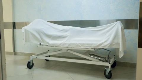 A dead body covered with a white cloth l... | Stock Video | Pond5