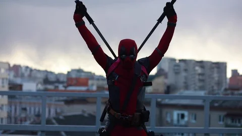 Deadpool cosplayer posing with guns and ... | Stock Video | Pond5