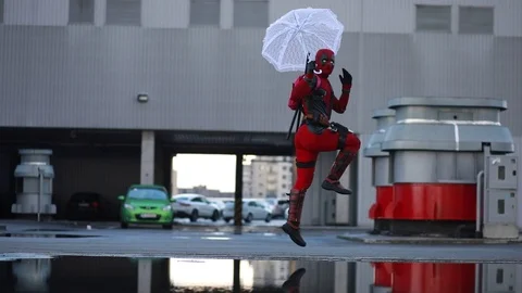 Deadpool cosplayer runs with weapon and ... | Stock Video | Pond5