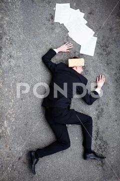 Photograph: Death, accident and brick on a business man lying on a ...