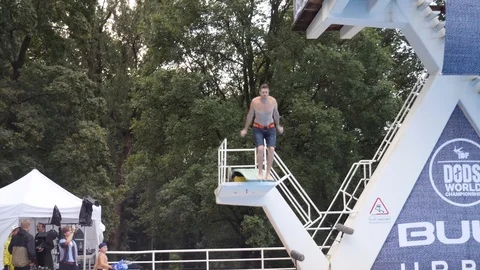 Death Diver jumps off the diving board a... | Stock Video | Pond5