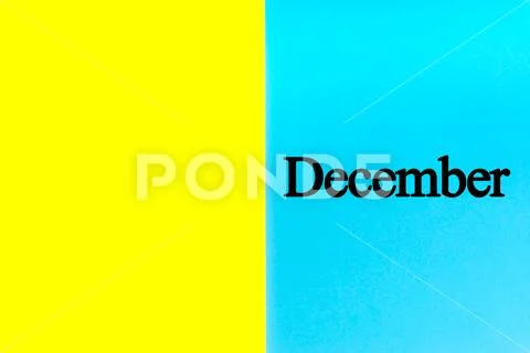 DECEMBER written words on blue and yellow background.: Graphic #106429277
