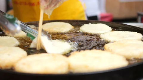Deep fried sweet cakes in floating hot b... | Stock Video | Pond5