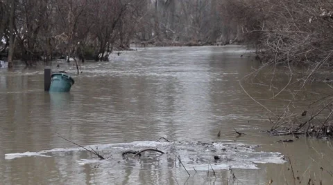 Deep water moving past trashcan on flood... | Stock Video | Pond5