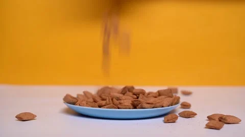 Delicious cereal pads fall into a blue p... | Stock Video | Pond5
