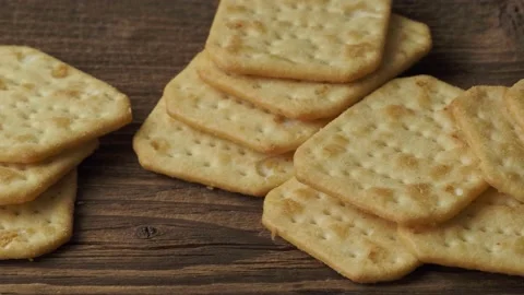 Delicious dry crackers on a wooden table... | Stock Video | Pond5