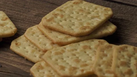 Delicious dry crackers on a wooden table... | Stock Video | Pond5