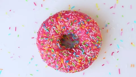 Delicious sweet donut rotating on a plat... | Stock Video | Pond5