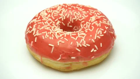 Delicious sweet red donut rotating on a ... | Stock Video | Pond5