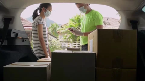 Delivery man handling a box from the veh... | Stock Video | Pond5