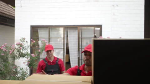 Delivery man move items to the house. | Stock Video | Pond5