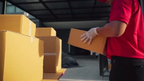 A delivery man wearing a red shirt grabs... | Stock Video | Pond5