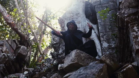 Demon Perched On Stone Wielding Sword | Stock Video | Pond5