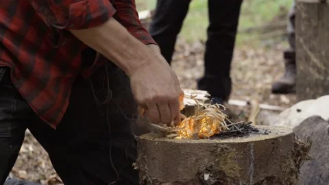 Demonstrating kindling of fire using fli... | Stock Video | Pond5