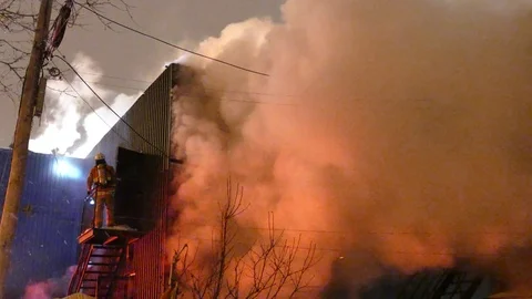 Dense smoke pouring out of back of build... | Stock Video | Pond5