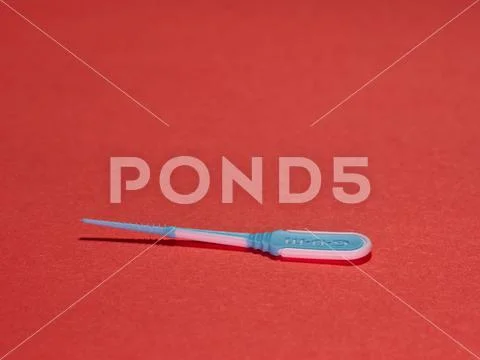 Dental toothpick with roughness made of rubber on a red background ~ Hi ...