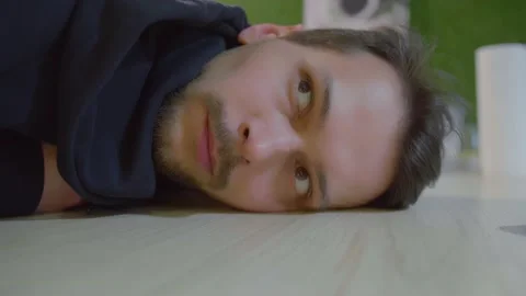 Depressed man puts his head on the table... | Stock Video | Pond5