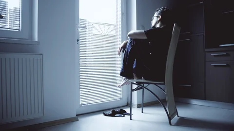 Depressed man at the window almost cryin... | Stock Video | Pond5
