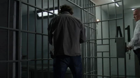 Depressed prisoner goes inside jail cell... | Stock Video | Pond5