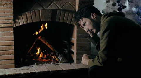 Depressed, sad man in front of a firepla... | Stock Video | Pond5