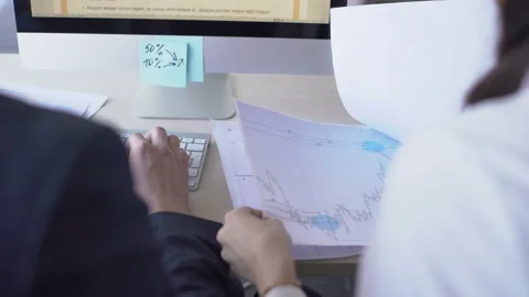 At desk hands of two people in office wo... | Stock Video | Pond5