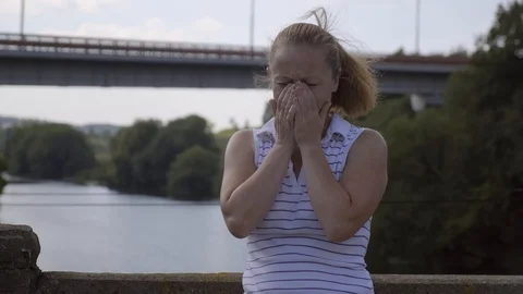 Desperate woman crying standing on a bri... | Stock Video | Pond5