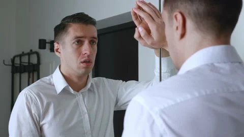 Desperate young man crying while looking... | Stock Video | Pond5