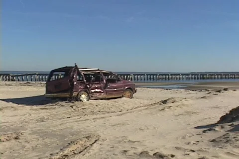 A destroyed minivan abandoned on a beach... | Stock Video | Pond5