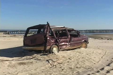 A destroyed minivan abandoned on a beach... | Stock Video | Pond5