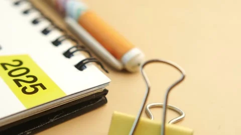 detail shot of a 2025 calendar on table, | Stock Video | Pond5