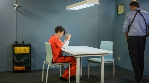 Detective enters the interrogation room ... | Stock Video | Pond5