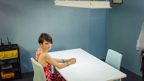 Detective enters the interrogation room ... | Stock Video | Pond5