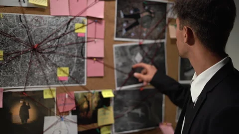 Detective looking at board with fingerpr... | Stock Video | Pond5