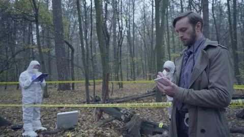 Detective making notes forensic experts ... | Stock Video | Pond5