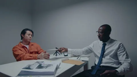 Detective Showing Evidence Photos to Sus... | Stock Video | Pond5