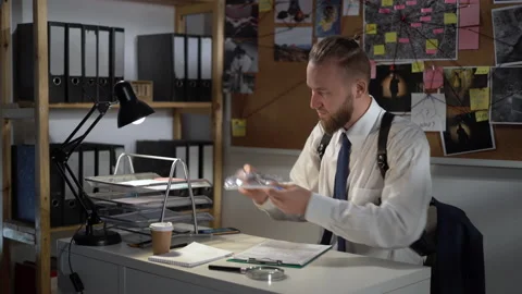 Detective working at desk in his office ... | Stock Video | Pond5