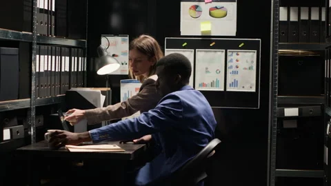 Detectives analyzing evidence and files | Stock Video | Pond5