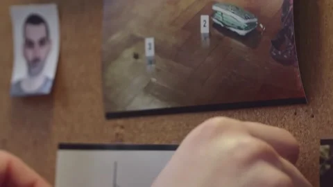 A detective's hands organize crime scene... | Stock Video | Pond5