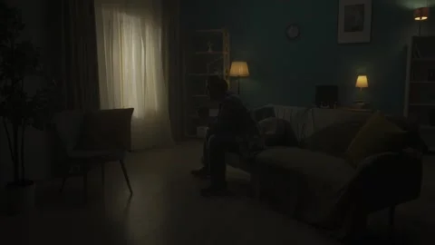 A devastated young man sits in a room in... | Stock Video | Pond5