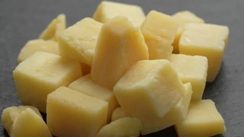 Diced cheese rotates on a black plate. D... | Stock Video | Pond5