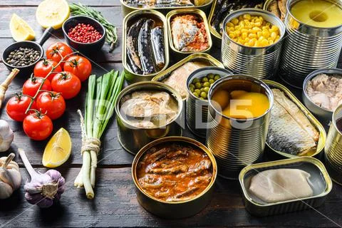 Photograph: Different canned conserve products in tin cans. with fresh ...