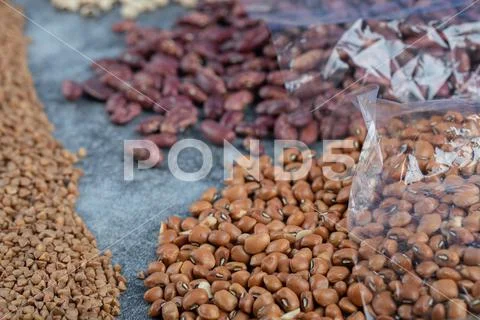 Different kinds of beans packed on a gray background ~ Hi Res #149124463