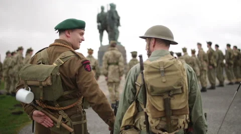 Different soldiers stand around war memo... | Stock Video | Pond5