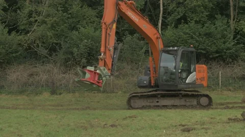 Digger excavator with tree shear attachm... | Stock Video | Pond5