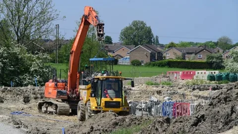 digger tipping rubble in earth moving tr... | Stock Video | Pond5