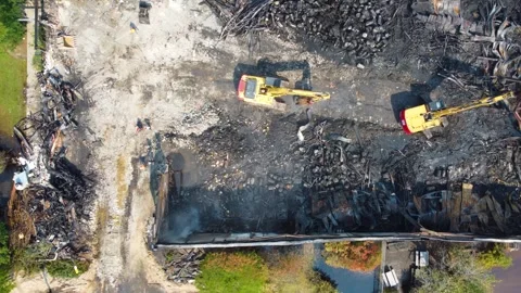Diggers cleaning up the remains of a bui... | Stock Video | Pond5
