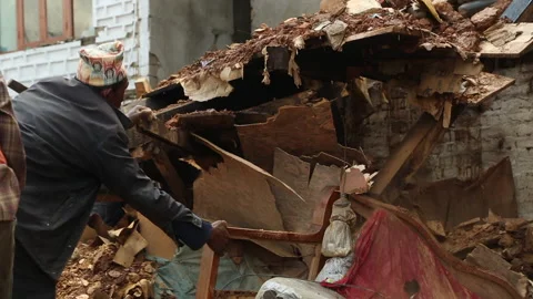 Digging out the rubble of a collapsed ho... | Stock Video | Pond5