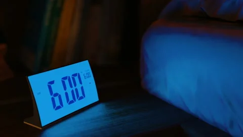Digital alarm clock waking up at 6 AM | Stock Video | Pond5