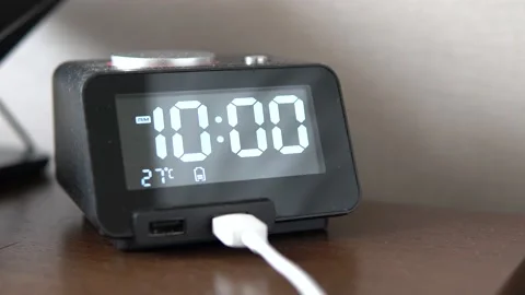 A digital clock on table showing 10am mo... | Stock Video | Pond5