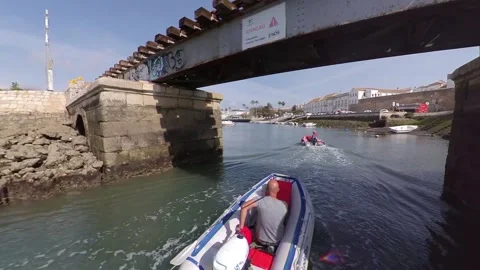 Dinghy ride passing under a small bridge... | Stock Video | Pond5